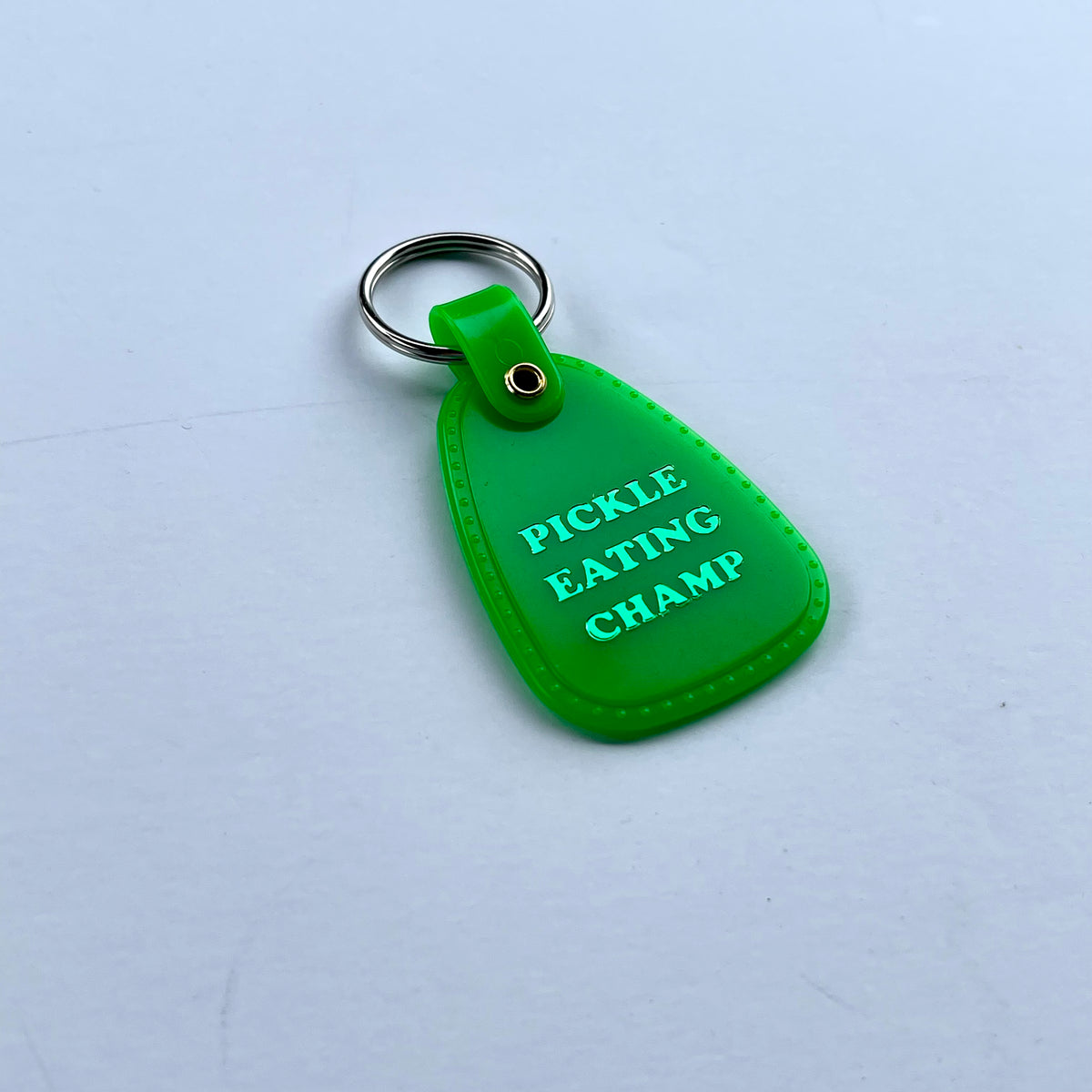 Pickle eating champ Saddle keychain – The Silver Spider